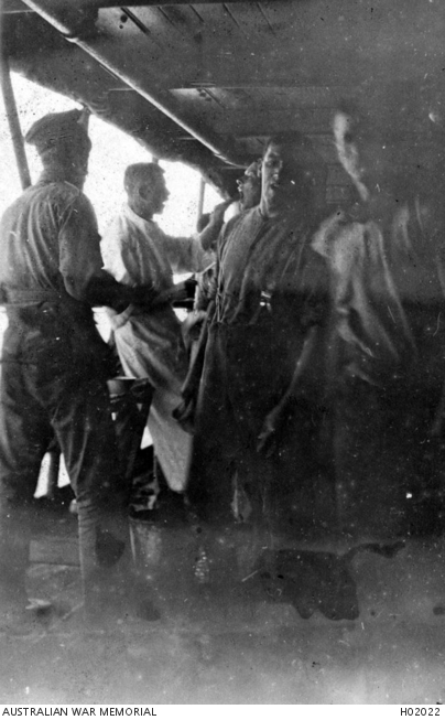 AT SEA. EXAMINING AND PAINTING THROATS ABOARD THE TROOPSHIP SS KYARRA ...