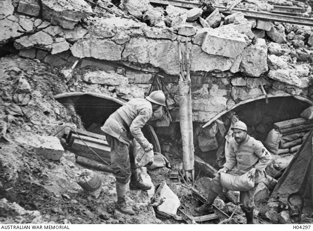 Two Belgian soldiers packing supplies into former German concrete ...