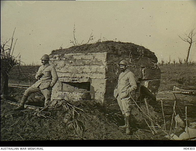 Two Belgian soldiers outside a former German Army machine gun concrete ...