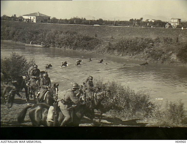 Italy. c. 1917. Italian cavalry troops exercising and crossing a river ...