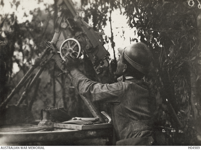 An Italian machine gunner in a forest. | Australian War Memorial