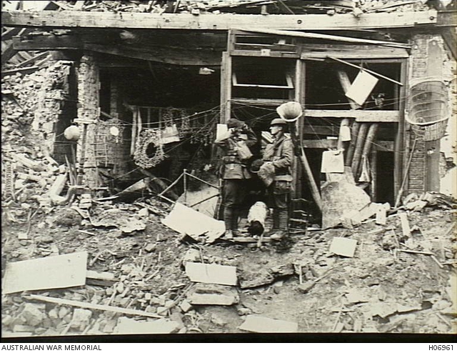 France. c. 1918. A Canadian Army soldier buying a hat from a second ...