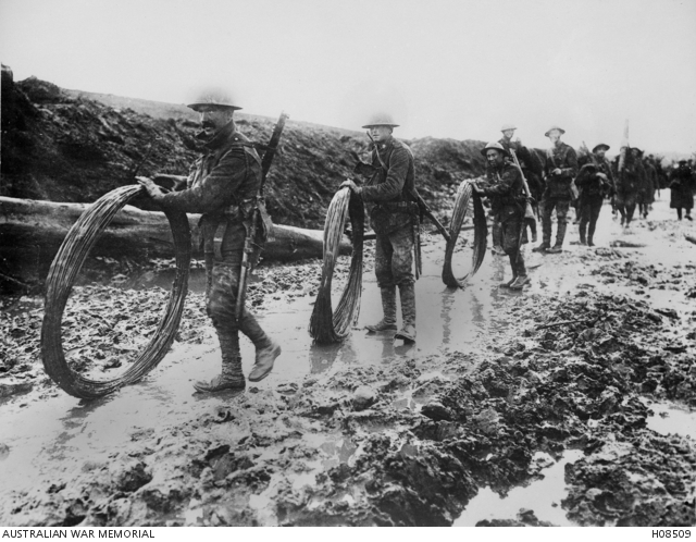 France. c. 1916. A British Army wiring party wheeling their wire ...
