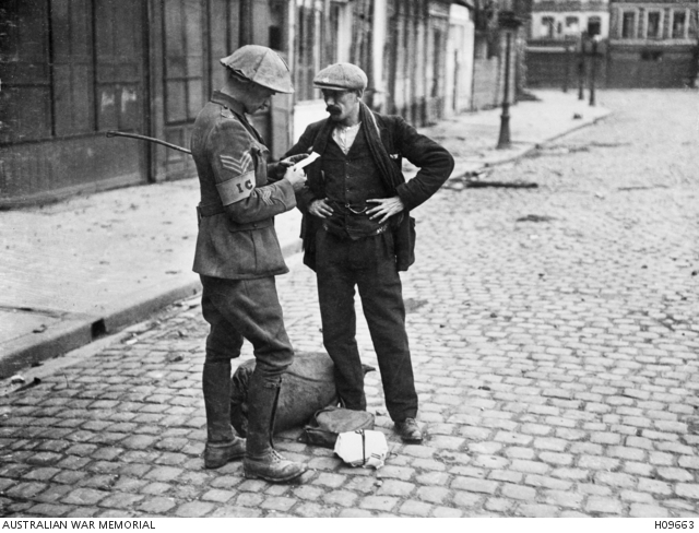Bethune, France. c. 1918. A British Army Intelligence sergeant checking ...