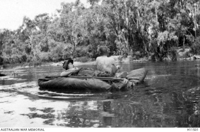Victoria. c. 1915. An improvised raft being rowed by two members of the ...