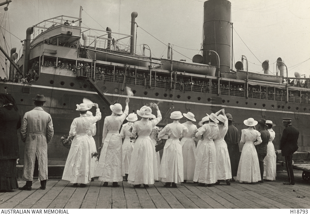 Red Cross ladies on a wharf welcoming the arrival of a troop transport ...