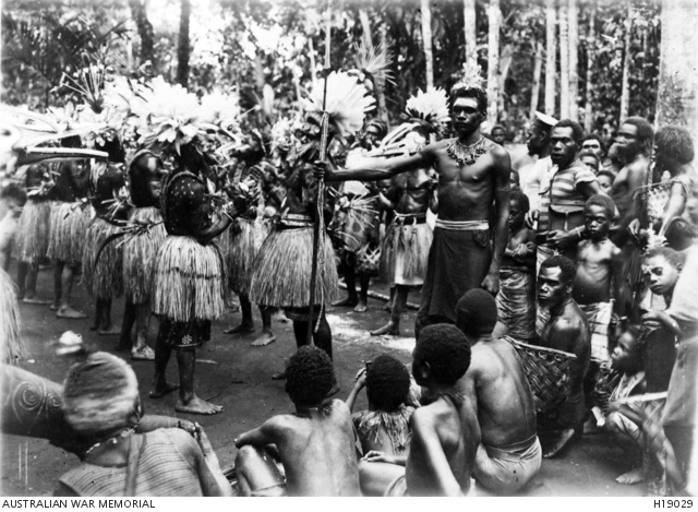 New Britain. A gathering of natives including a group performing a Sing ...