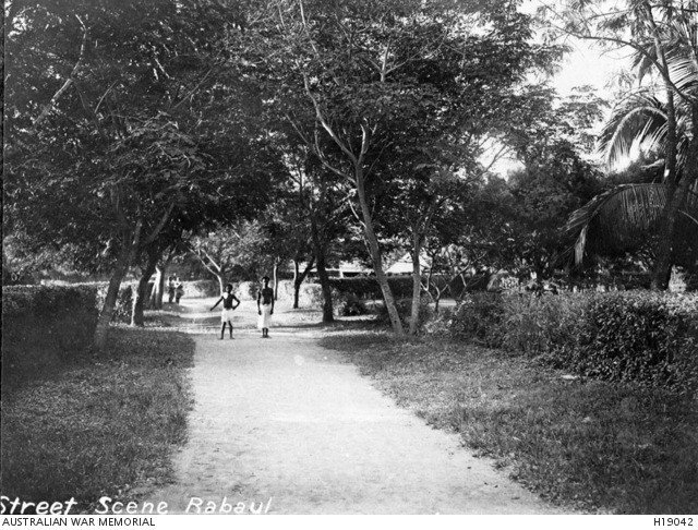 Rabaul, New Britain. A street scene in the suburbs with two natives ...
