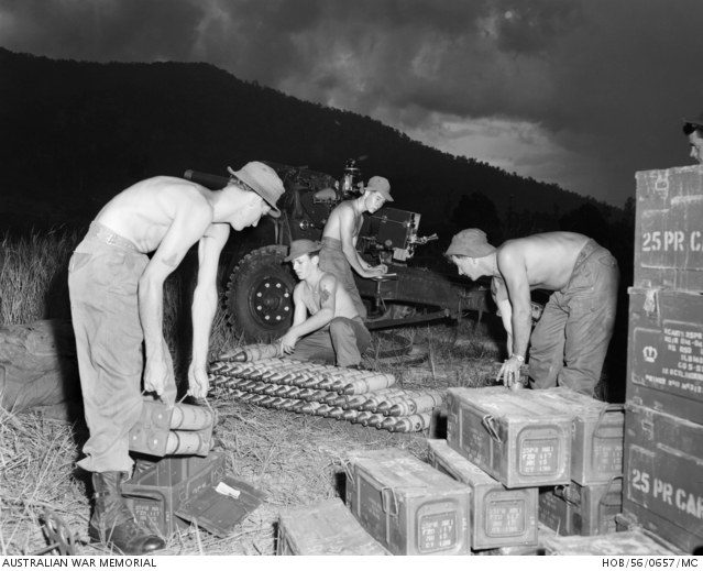Working quietly but steadily in the fading light, gunners of A Troop ...