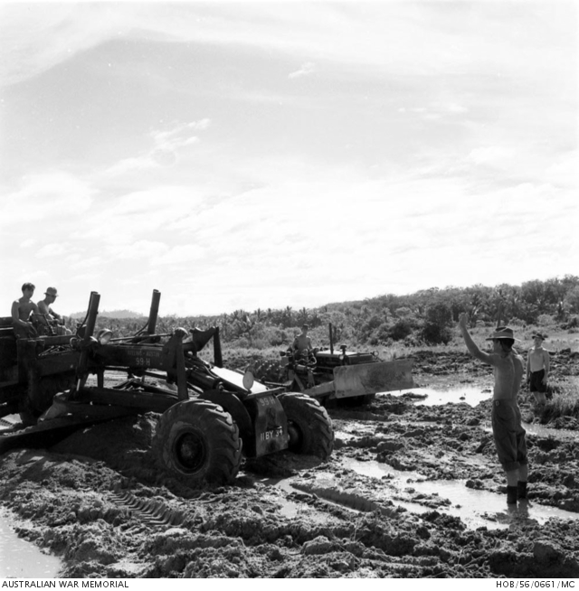 With raised arm and mud up to his ankles, 3/5858 Lance Corporal Tong ...