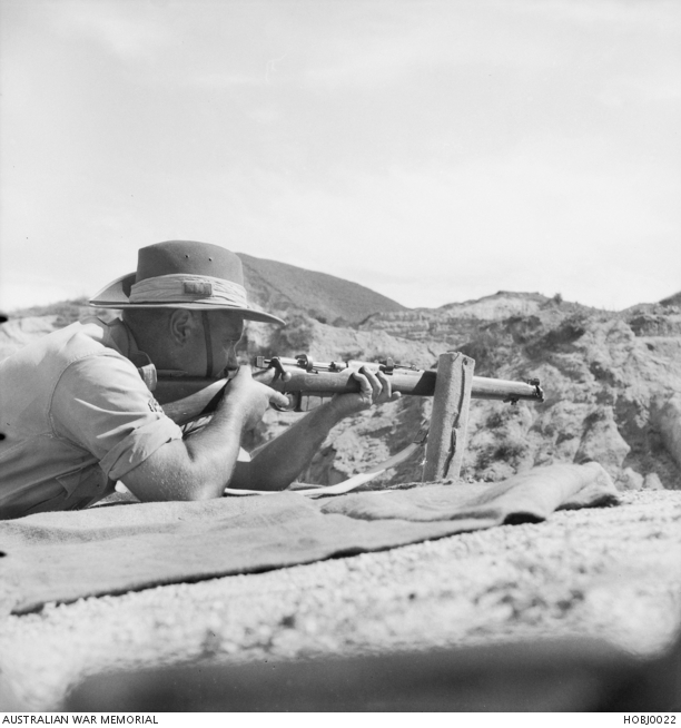 Unidentified Australian army Warrant Officer Class 2 (WO2) taking aim ...