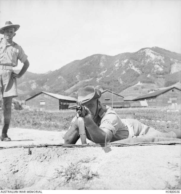 Unidentified Australian army Warrant Officer Class 2 (WO2) taking aim ...