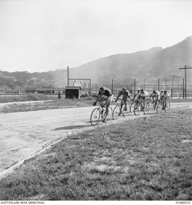 Unidentified cyclists entering the home stretch of a bicycle race. The ...