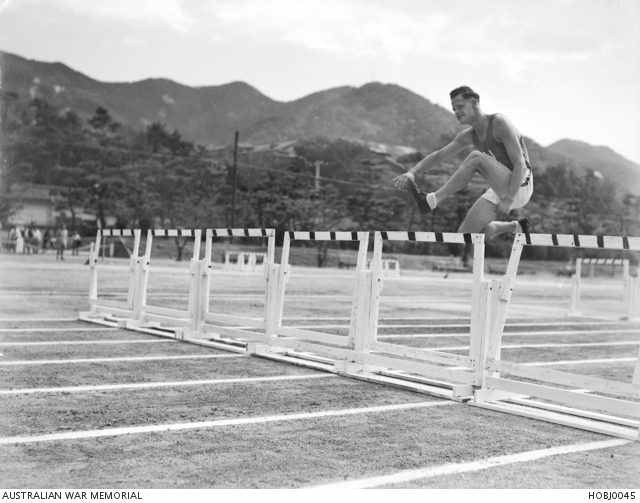 3843 Corporal Larence Joseph 'Larry' Moon competes in a hurdles event ...