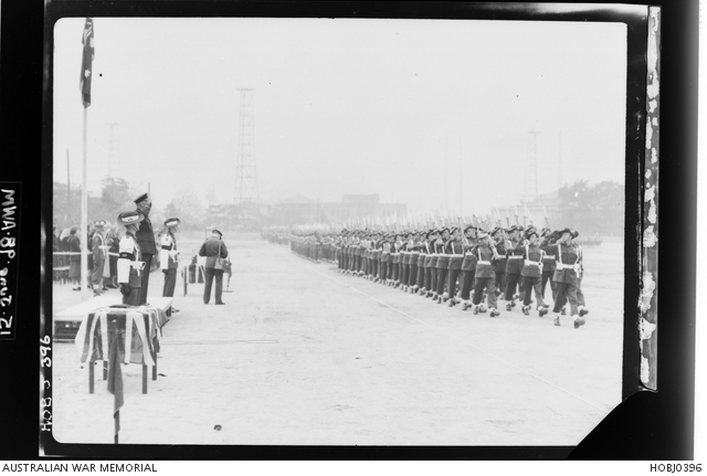 Australian Army troops, in dress uniform, march past the dais (left ...