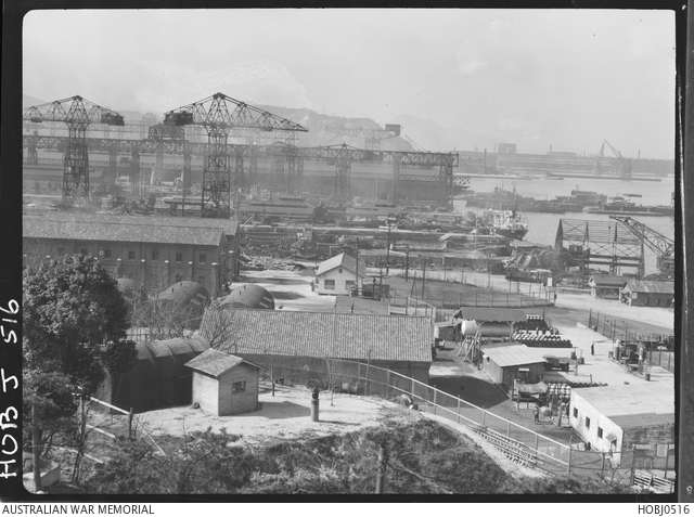 An elevated view of the Kure docks area. Note the many large cranes ...