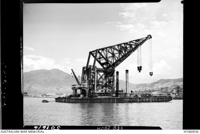 A view of a floating crane in Kure harbour during the visit of ships ...