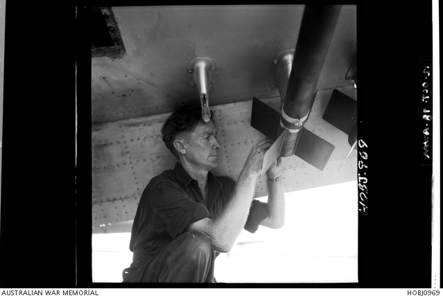 An unidentified RAAF armourer from 77 Squadron RAAF, fits High Velocity ...