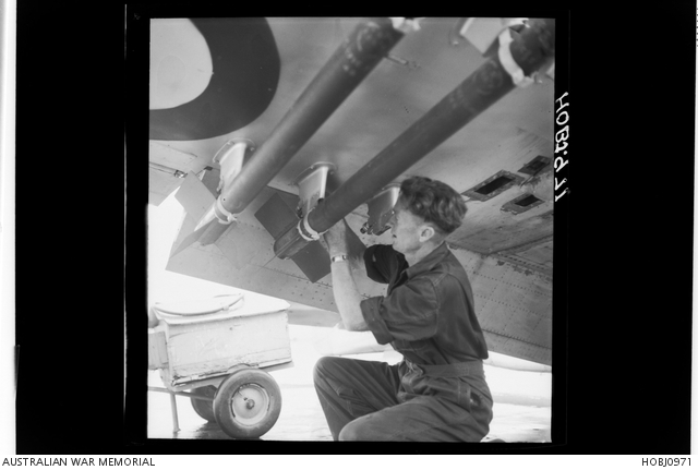 An unidentified RAAF armourer from 77 Squadron RAAF, fits High Velocity ...