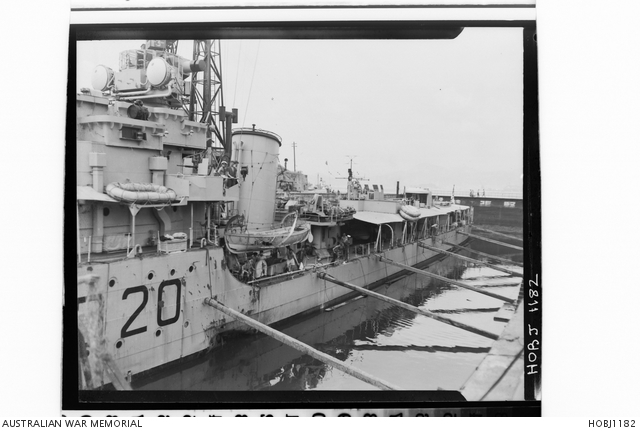 Port side view of the Royal Navy destroyer HMS Comus (D20) in dry dock ...