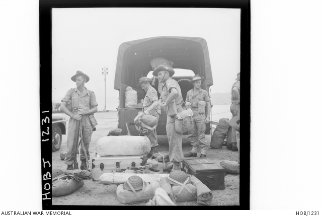 Unidentified Australian Army troops load equipment and personal ...
