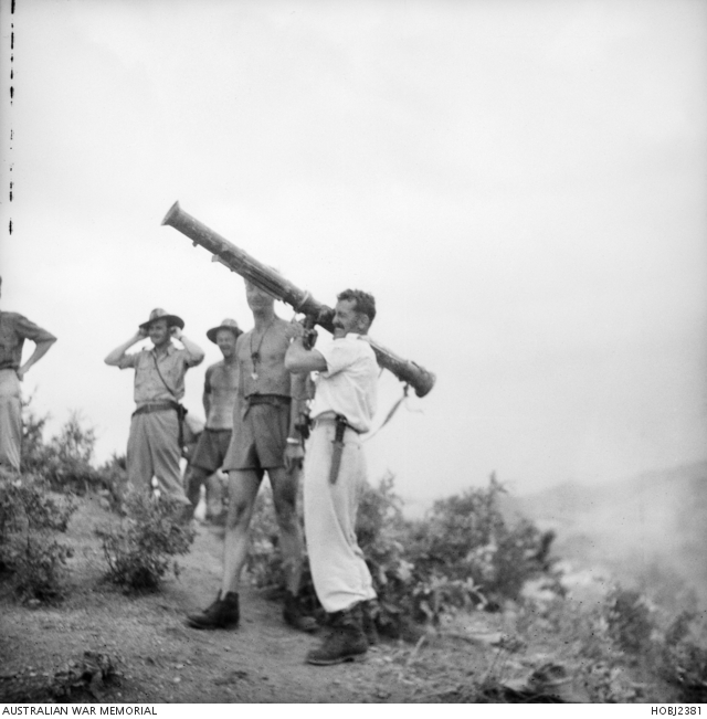 A group of unidentified Australians watching a demonstration firing of ...