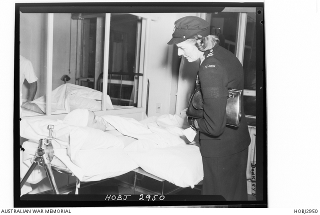 Lady Edwina Mountbatten stops to talk with an unidentified patient ...