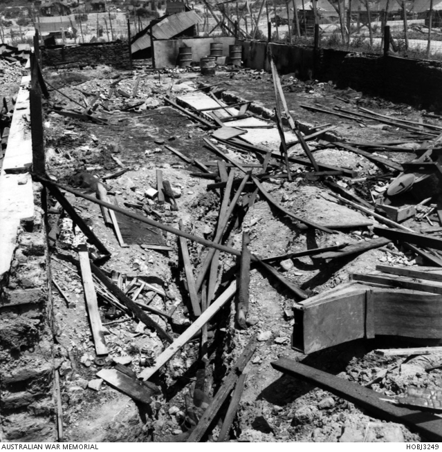 A view of an area where sheds or barracks have been destroyed, probably ...