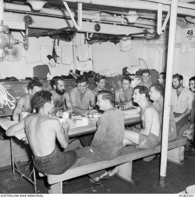Unidentified crewmembers of the RAN destroyer HMAS Bataan relaxing in ...