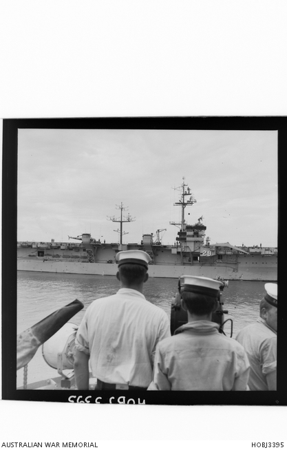 Unidentified crewmembers of the RAN destroyer HMAS Bataan observe their ...