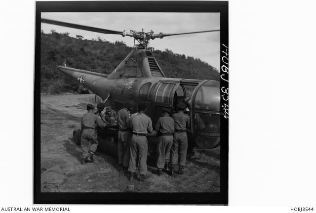 Wounded soldiers are loaded onto a Sikorsky S-51 Dragonfly helicopter ...