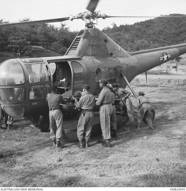 Wounded soldiers are loaded onto a Sikorsky S-51 Dragonfly helicopter ...