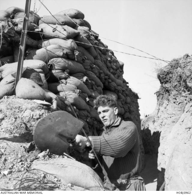 Korea. January 1953. Private Jim Hough of South Perth, WA, digging near ...
