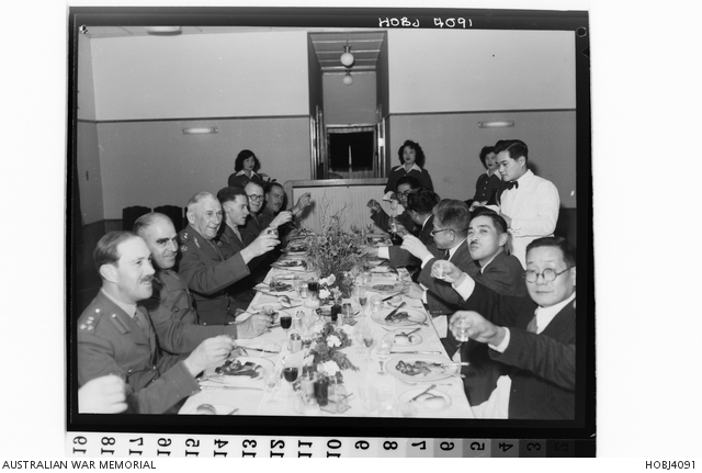 A group of businessmen (mostly Japanese) and senior Army officers hold ...