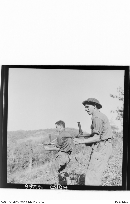 Testing their Owen guns by firing them are, Private Kevin Jones of ...