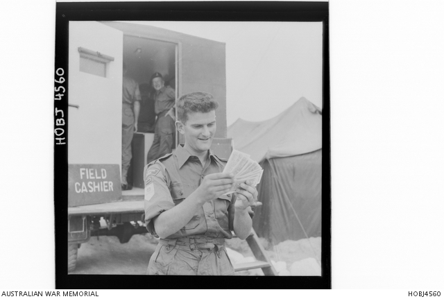 Outside the Mobile Field Cash Office, Private Tony Poole of The Basin ...
