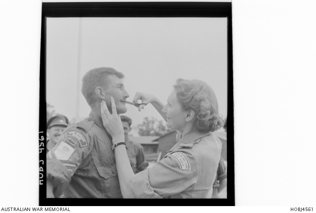 Corporal Don Buck of Sydney, NSW, receives a moustache trim from Red ...