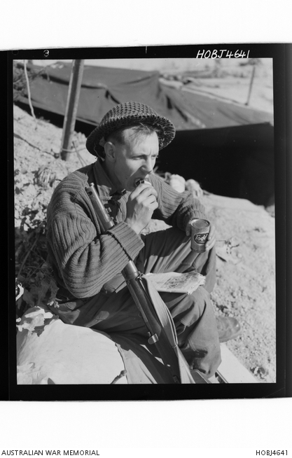 Private Vic Eaton of Waverley, NSW, sits on his bed roll outside the A ...