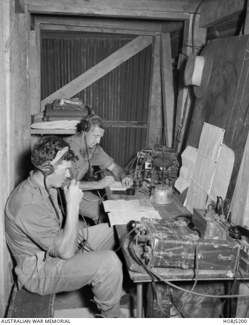 Two unidentified soldiers at work, communicating by radio, in the ...