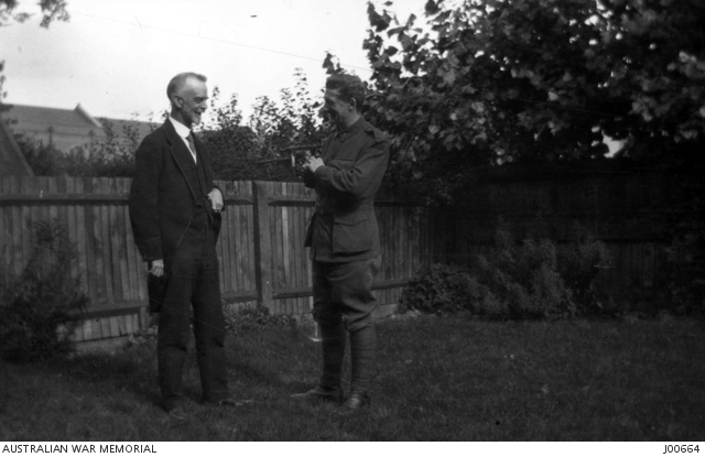 Mr A T Sharp and a friend in a friendly discussion in the backyard of ...