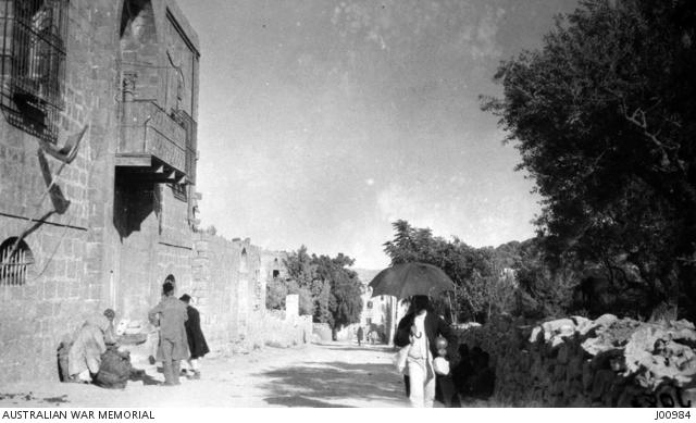 A local street scene in Hebron, Palestine, showing a woman holding an ...