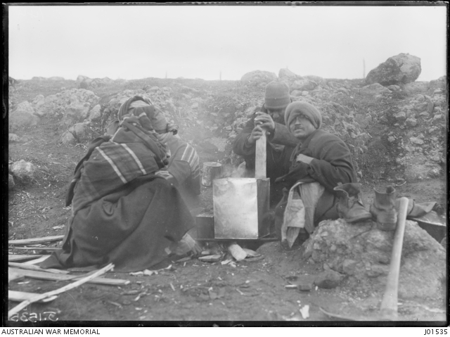 Captured Turkish soldiers cooking food and wraped up against the cold ...