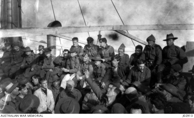 A POPULAR PASTIME. TROOPS ABOARD THE S.S. "ORCA" RETURNING TO AUSTRALIA ...