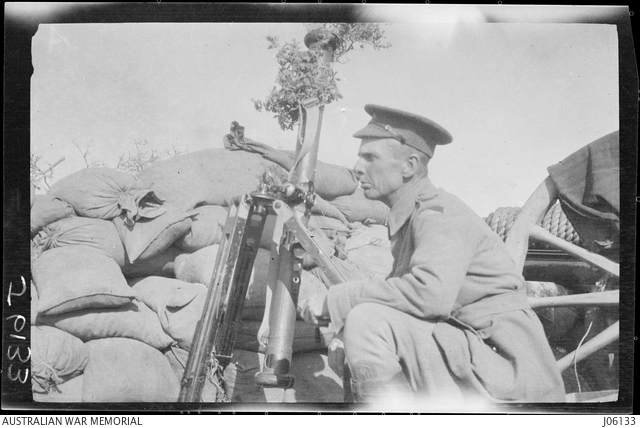 MAJOR HUGHES AT HIS RANGE FINDER, (CAMOUFLAGED WITH BUSHES,) IN THE ...