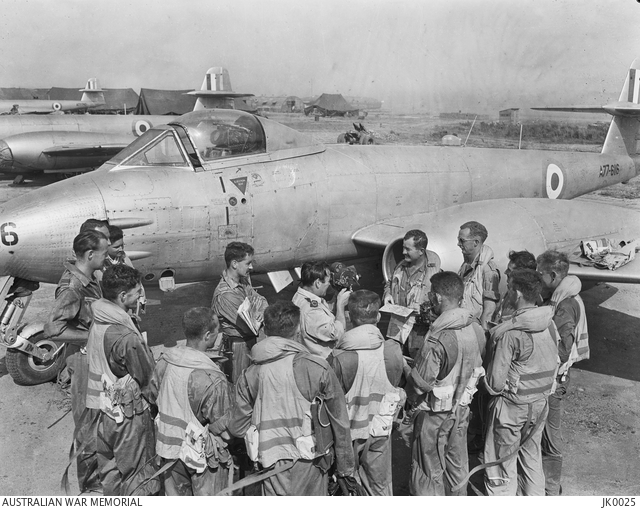 Pilots of 77 Squadron RAAF, being briefed by their Commanding Officer ...
