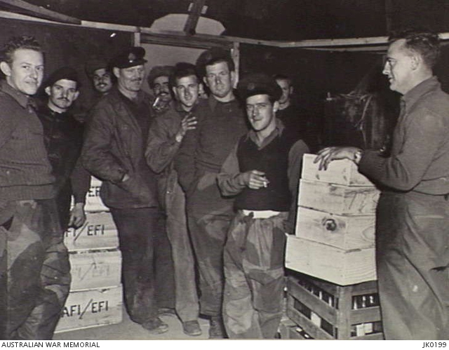 KIMPO, SOUTH KOREA. 1951-12. CORPORAL BERNIE HIGGINS HANDS OUT ...