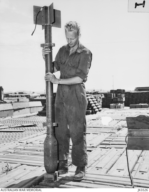 KIMPO, SOUTH KOREA, 1952. HIGH EXPLOSIVE ROCKET PROJECTILE IS PREPARED ...
