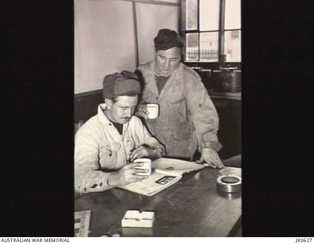IWAKUNI, JAPAN. 1952. HAVING A CUP OF TEA AND SHARING A MAGAZINE ARE ...