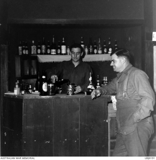An unidentified soldier pours a stein of beer at the bar of a club in ...