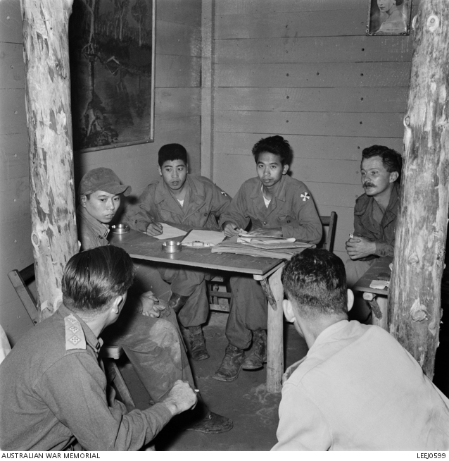 A Chinese prisoner of war (POW) (left, next to pole), captured on the ...